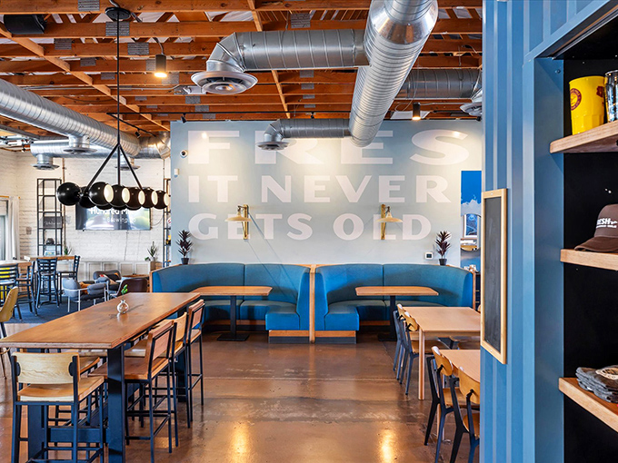 Exposed wooden beams meet industrial chic in this airy space where "BEER: IT NEVER GETS OLD" isn't just wall art&mdash;it's a lifestyle.