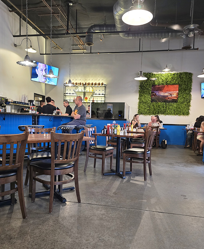 Inside, industrial meets Southwest charm with exposed ducts, concrete floors, and that eye-catching blue wainscoting that makes the whole place pop.