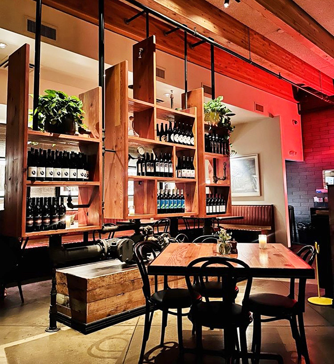 Warm wood shelving displays bottles like treasures in a museum of flavor, while the intimate seating invites you to settle in for something special.