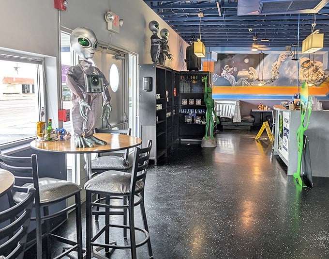 Green aliens flash peace signs while watching diners enjoy their meals &ndash; possibly taking notes on human eating habits for their research.