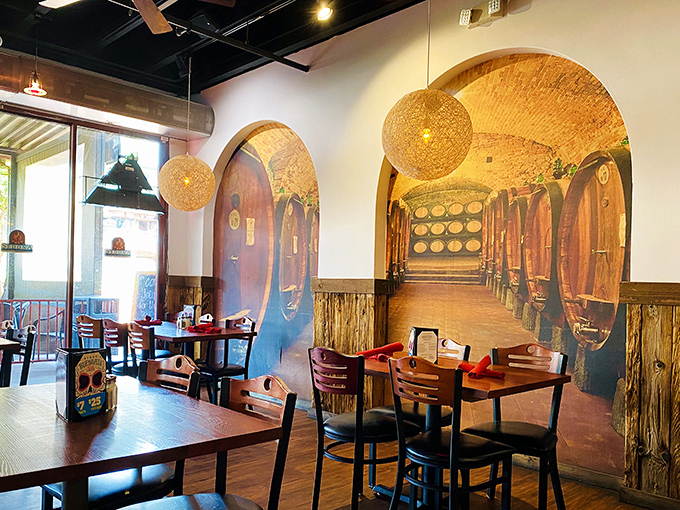 Wine barrel murals transport diners to vineyard cellars, creating an atmosphere that's both sophisticated and welcoming. Those pendant lights add just the right glow!