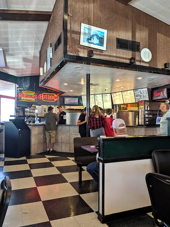 Black and white checkered floors meet wood-paneled walls in this time capsule of American dining, where conversations flow as freely as the milkshakes.