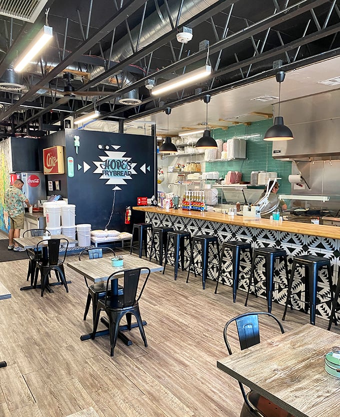 Industrial-chic meets Southwestern charm in this thoughtfully designed interior, where black metal stools line a counter adorned with traditional patterns.