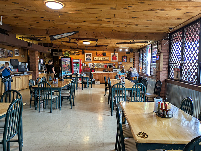 Rustic wooden tables and chairs fill the warm interior, where Route 66 nostalgia meets comfortable dining in perfect harmony.