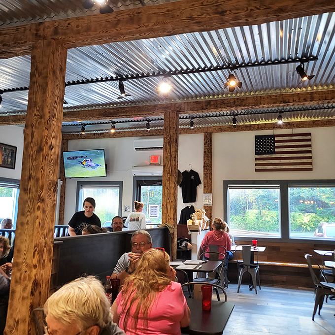 Rustic wooden beams meet modern comfort inside Mooselook Diner, where locals and travelers gather beneath the corrugated metal ceiling for burger perfection.