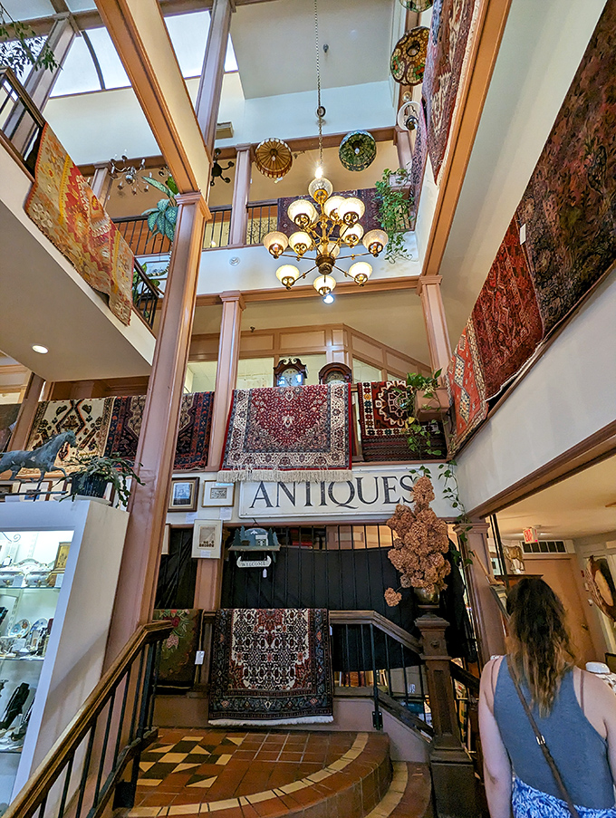 Soaring ceilings and elegant chandeliers create a cathedral-like atmosphere for antiquing, where history breathes through every carefully curated corner.