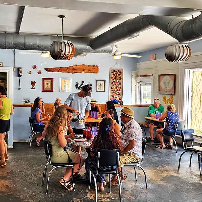 Blue walls, vintage lighting, and a buzzing atmosphere create the perfect backdrop for breakfast magic. Every table tells a different morning story.