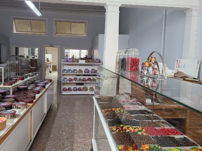 Glass display cases stretch like treasure chests filled with handcrafted delights that would make Willy Wonka jealous.