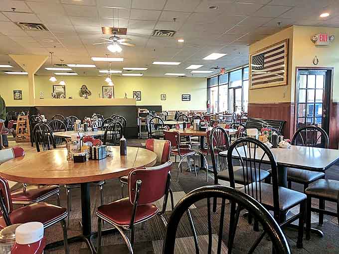 Interior: Classic diner charm meets neighborhood comfort &ndash; red vinyl chairs and wooden tables create the perfect canvas for breakfast masterpieces.