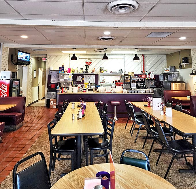 Inside, the classic diner setup promises comfort without pretension. Those counter stools have supported thousands of happy breakfasters contemplating their next coffee refill.