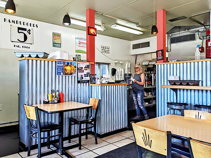 Step inside to find nostalgic corrugated metal wainscoting, red accents, and a "Hamburgers 5&cent;" sign that whispers of simpler times &ndash; comfort food's natural habitat.