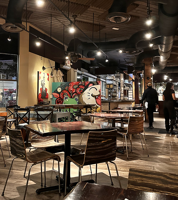 Industrial meets intimate in Dragonfly's dining space, where exposed ductwork hovers above conversations and culinary revelations.