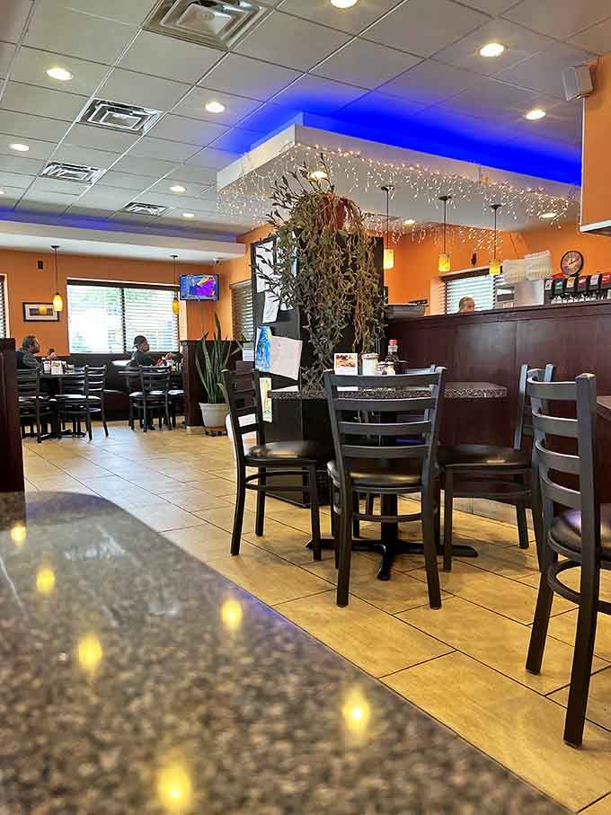 Warm orange walls meet cool blue accent lighting, creating the perfect atmosphere for morning conversations or midday meetups.