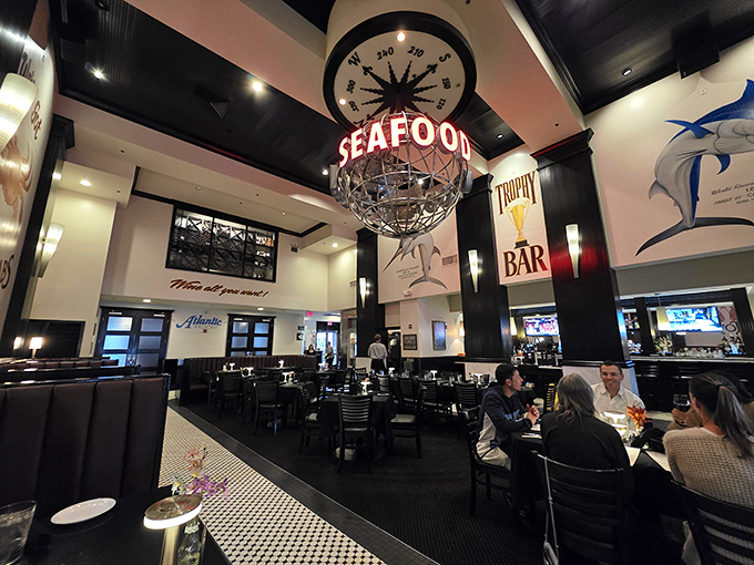 A dramatic globe chandelier proclaiming "SEAFOOD" hovers above diners like a North Star for seafood lovers, guiding them to culinary bliss.