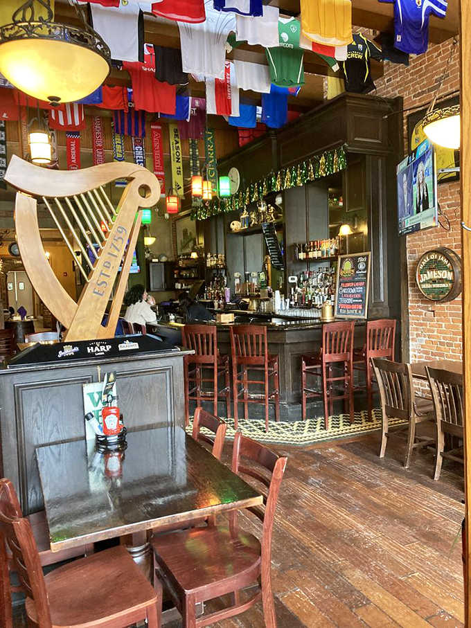 Flags from around the world create a colorful canopy above the rich wooden interior, where the carved harp stands as a silent tribute to Irish musical heritage.