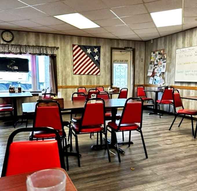 Red chairs pop against neutral walls in this dining room where conversations flow as freely as the coffee.