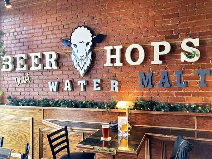 Exposed brick walls meet wooden warmth inside, where the brewery's sheep logo watches over patrons enjoying liquid craftsmanship in this converted historic building.