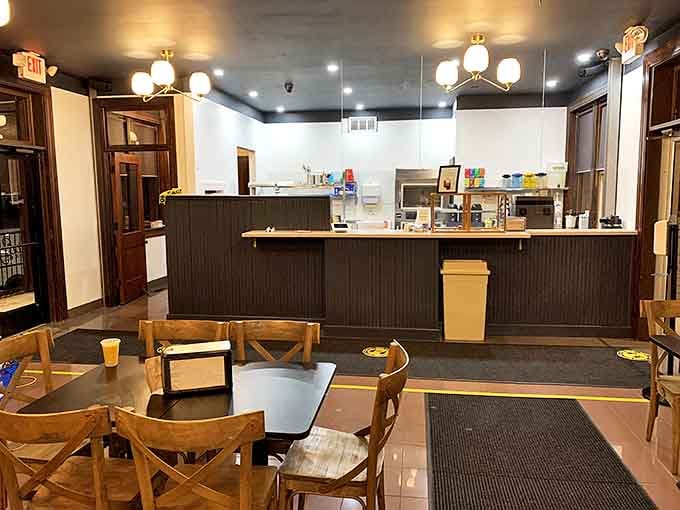 Simple wooden tables and warm lighting create the perfect stage where buttery masterpieces take their well-deserved bow.