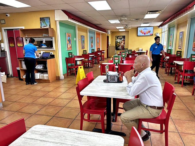 Cheerful yellows and greens create a welcoming atmosphere where locals gather, proving great food brings people together regardless of language barriers.
