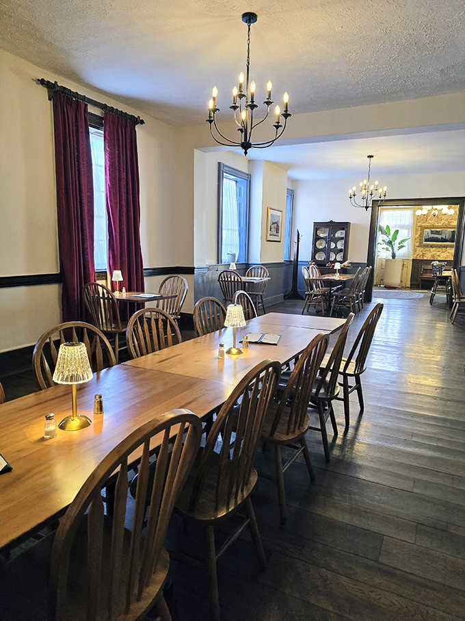 Elegant simplicity defines the dining room, where Windsor chairs and warm lighting create the perfect setting for conversations that flow as smoothly as the service.