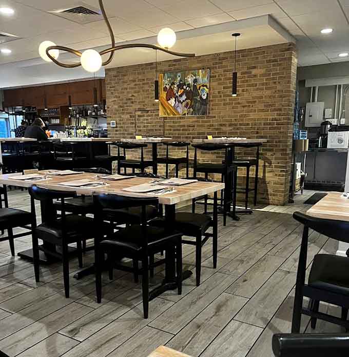 Modern meets cozy in this thoughtfully designed interior, where exposed brick and stylish lighting create the perfect backdrop for memorable meals.