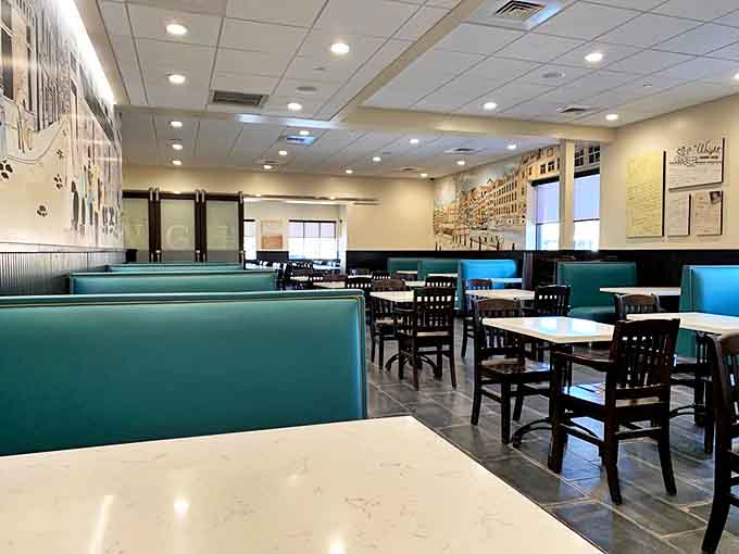 Teal booths and dark wood create a timeless dining atmosphere where conversations flow as freely as the sweet tea.