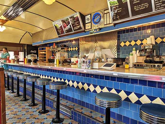 Blue tile work gleams against chrome fixtures as vintage counter stools invite you to belly up for a meal that transcends time. The perfect backdrop for conversations that matter.