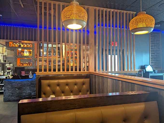 Woven pendant lights and tufted booths create an inviting atmosphere where the focus stays squarely on the food.