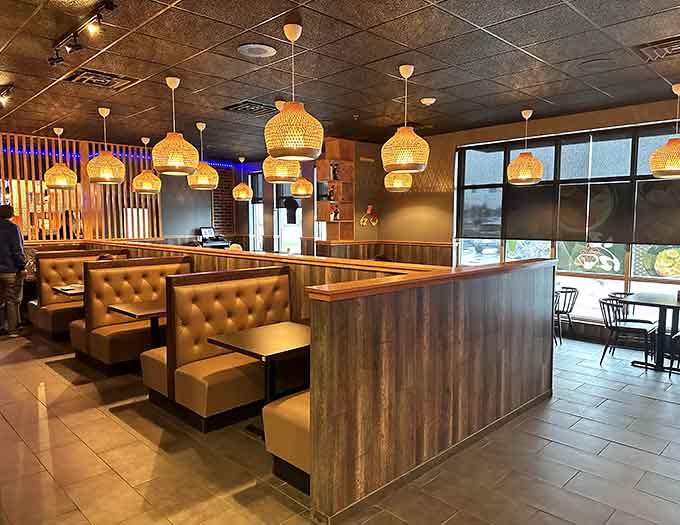 Warm lighting and woven pendant fixtures create an inviting atmosphere that makes you want to settle in for hours.