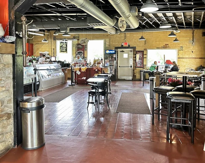 Industrial chic meets neighborhood warmth in this inviting space where exposed ducts and cozy lighting create the perfect breakfast atmosphere.