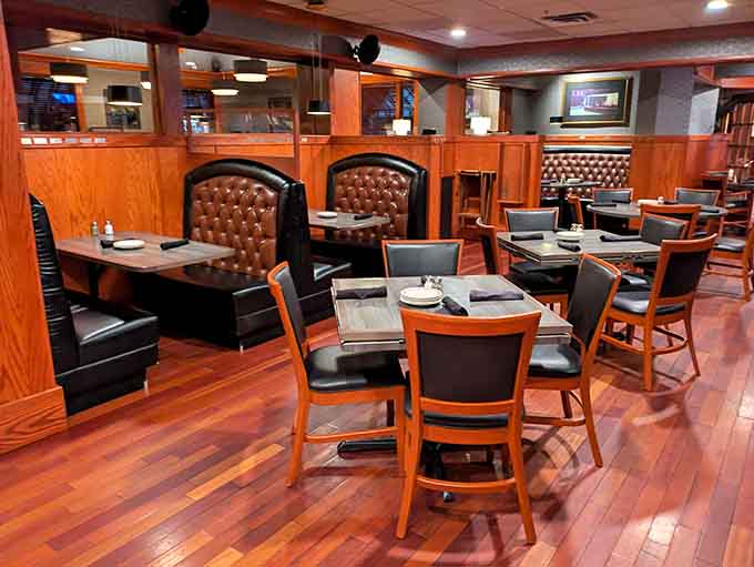 Tufted leather booths and warm wood paneling create an atmosphere that whispers "stay awhile" to every guest.