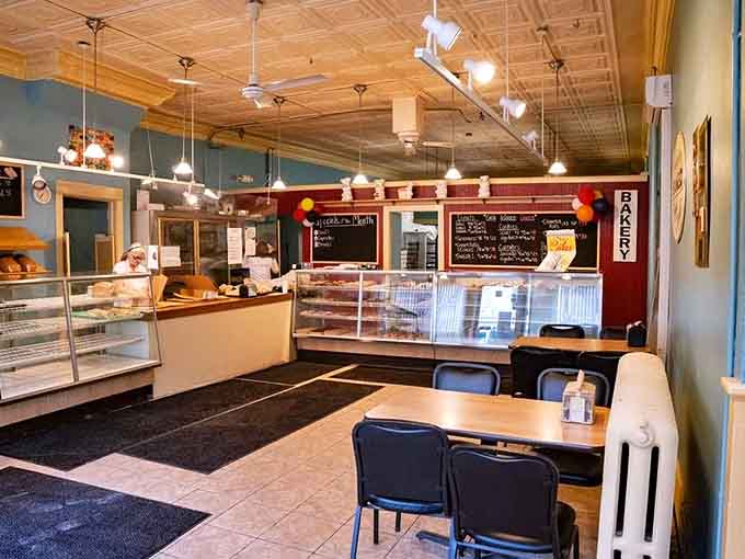 Vintage charm meets modern comfort in this welcoming space where tin ceilings and warm lighting create the perfect pastry paradise.