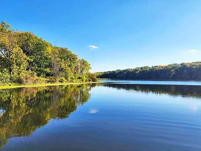 The lake reflects the sky like nature's own mirror, making you wonder why anyone bothers with indoor pools.