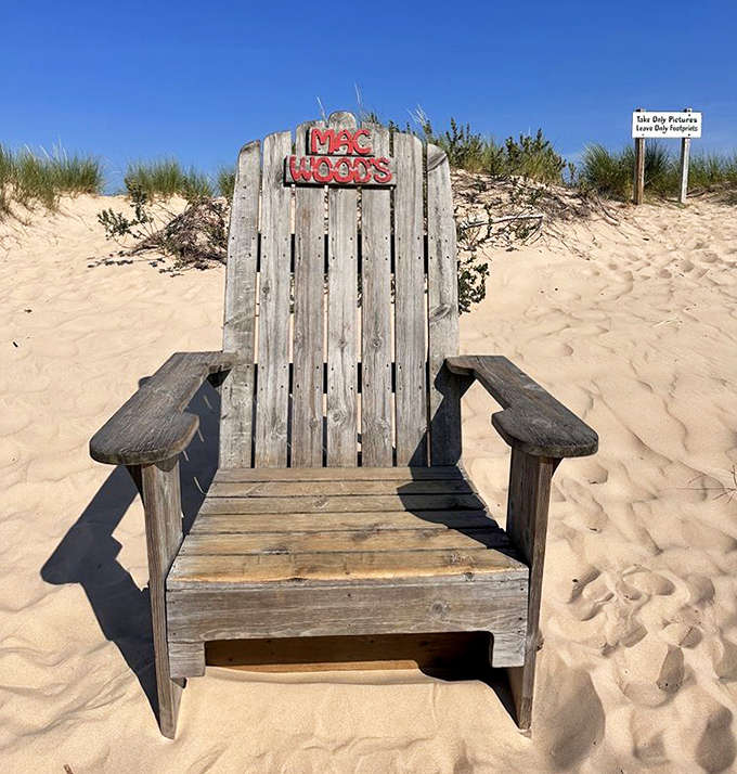 This weathered wooden throne isn't just a chair – it's a sandy sentinel offering momentary respite between dune-conquering adventures.
