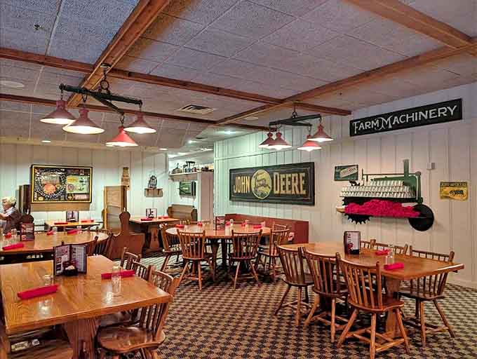 Wooden tables, farm memorabilia, and John Deere signage create an authentic atmosphere where comfort food finds its perfect home.