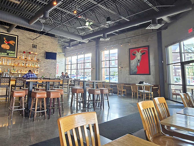 Industrial chic meets Midwestern charm in this airy dining space where exposed brick and that striking red goat artwork create conversation starters.