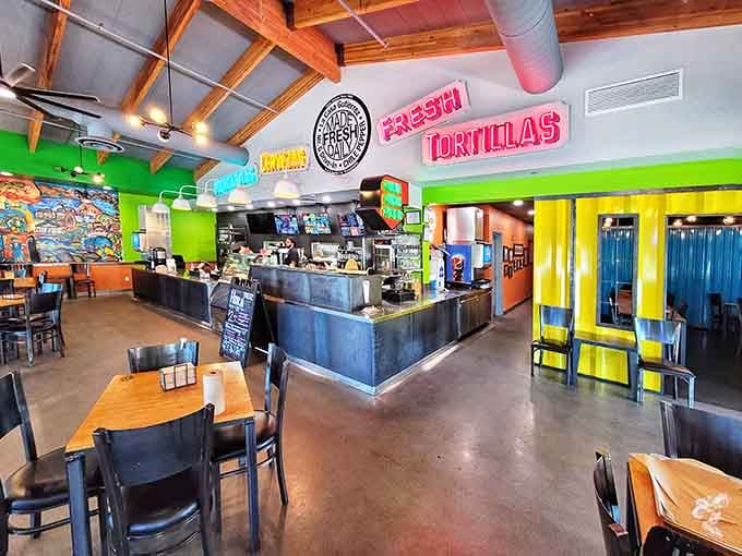 Lime green walls and exposed beams create a fiesta atmosphere where every meal feels like a celebration worth attending.