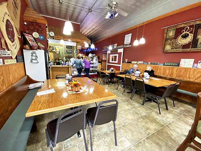 Interior: Where magic happens daily – simple wooden tables, warm lighting, and the promise of deliciousness create the perfect small-town bakery atmosphere.