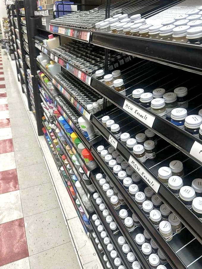 Rows of meticulously organized paint bottles await creative minds &ndash; each tiny container holding possibilities for bringing miniature worlds to life.