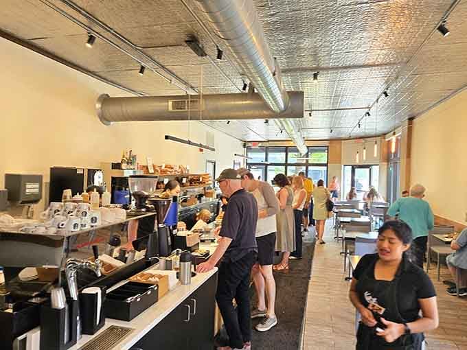 Clean lines and warm lighting create the perfect backdrop for pastry perfection, where industrial chic meets French elegance beautifully.