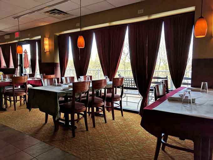 Floor-to-ceiling curtains and warm lighting create an ambiance that whispers "special occasion" even if it's just Tuesday and you're celebrating surviving Monday.