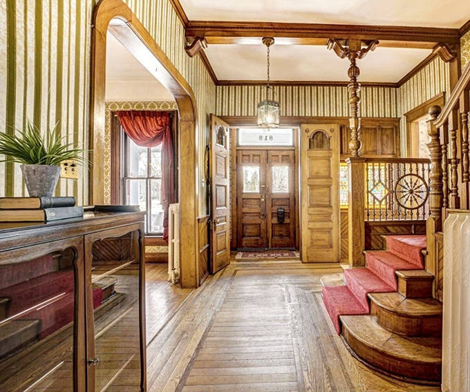 Step through these doors and travel back to 1876 – the entryway's striped wallpaper and wooden details whisper tales of bygone elegance.