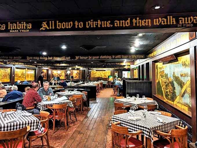 Literary wisdom adorns the ceiling while diners below savor century-old recipes in this warmly lit, history-soaked dining room.