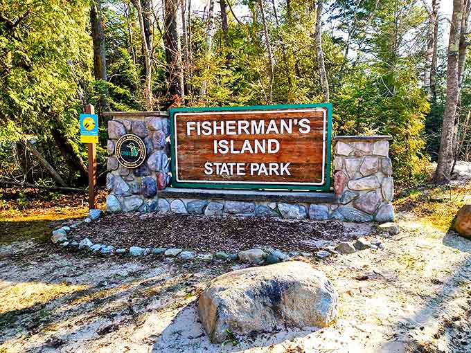 The welcoming sign stands like a promise of adventure, stone pillars anchoring it to earth while your imagination already floats toward that perfect beach day.