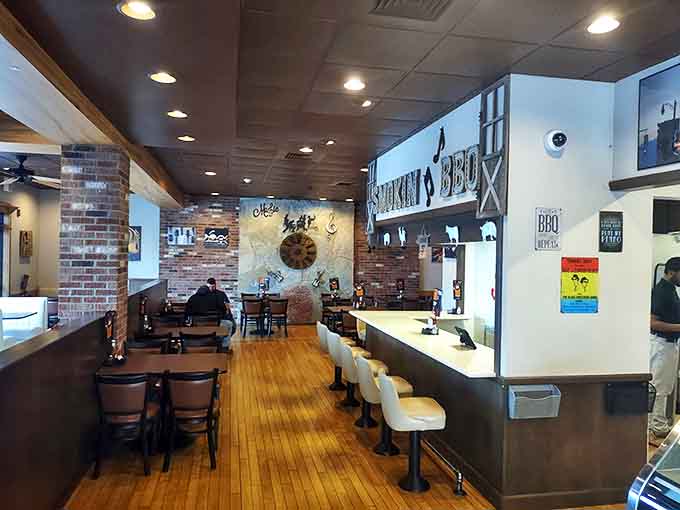 Warm wood floors, exposed brick, and comfortable seating create the perfect backdrop for the serious business of barbecue enjoyment.