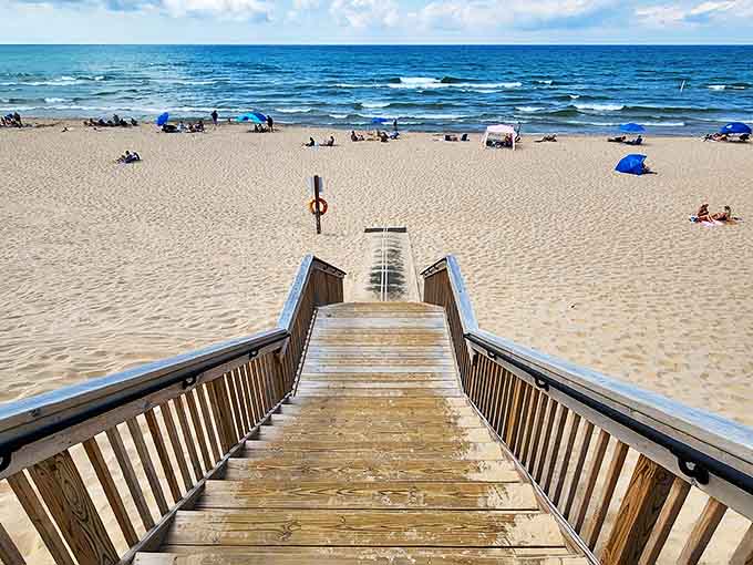 The wooden staircase beckons visitors down to paradise, each step bringing you closer to that moment when worries dissolve into Lake Michigan's horizon.