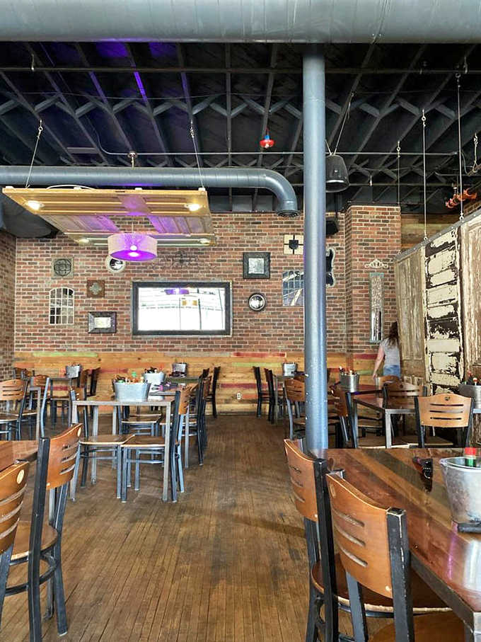 Exposed brick, industrial touches, and warm lighting create an atmosphere that's both hip and homey, like your cool aunt's loft apartment.