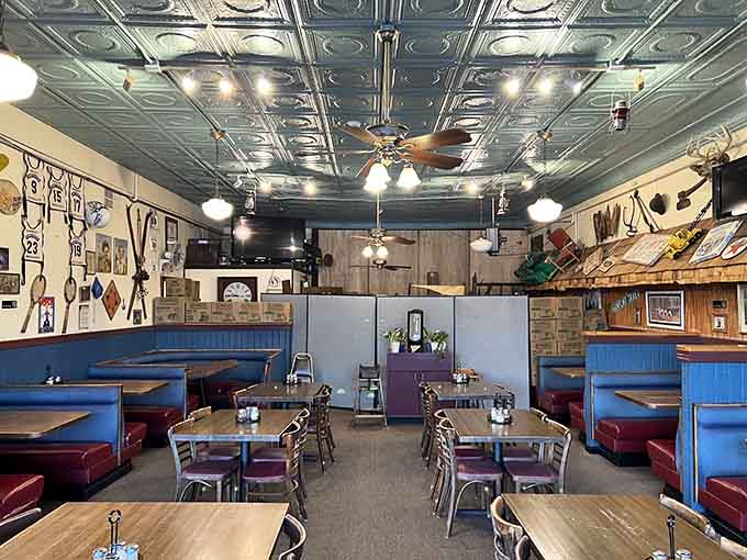 Tin ceilings and cozy booths create the perfect atmosphere for devouring pizza with family and friends in this welcoming space.
