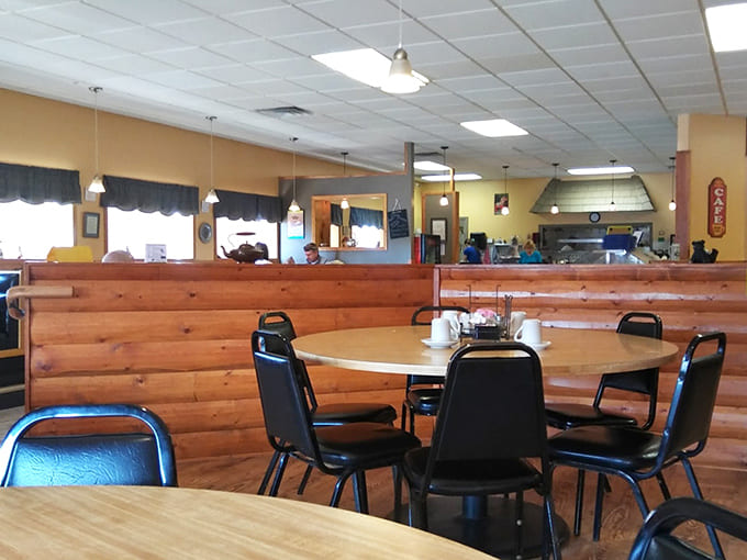 Honey-colored wooden booths create a warm, cabin-like atmosphere where conversations flow as freely as the coffee refills.