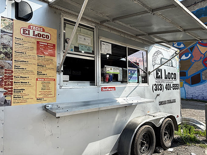 A closer look at taco perfection headquarters – where the magic happens behind a simple service window and "OPEN" sign.